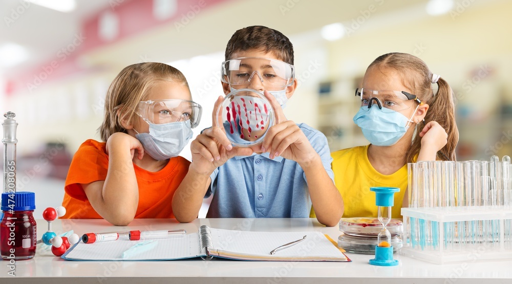 Happy school pupil student using working at biology chemistry lesson ...