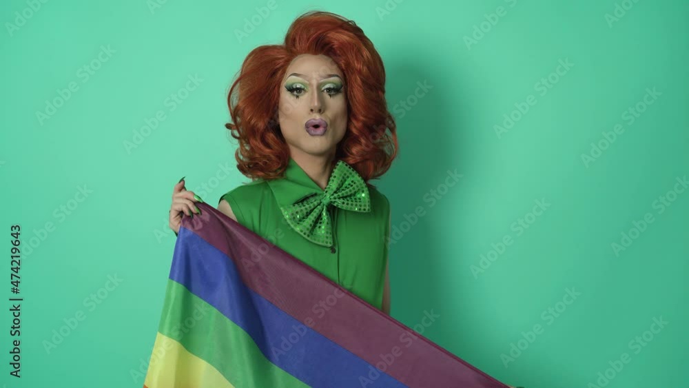 Drag queen celebrating gay pride holding rainbow flag symbol of LGBTQ ...