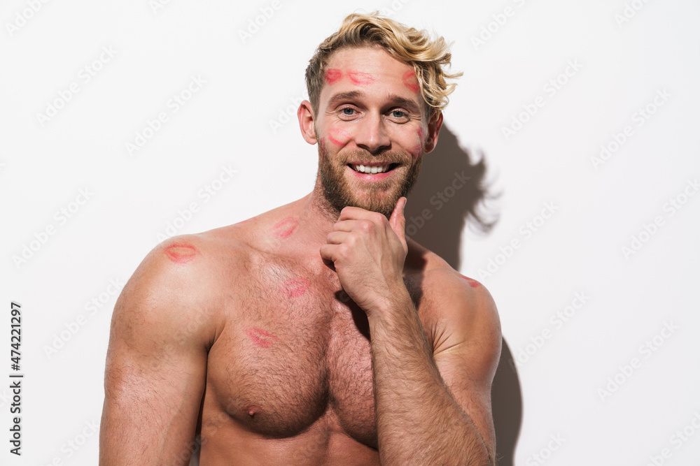 White shirtless man with lipstick marks smiling and looking at camera ...