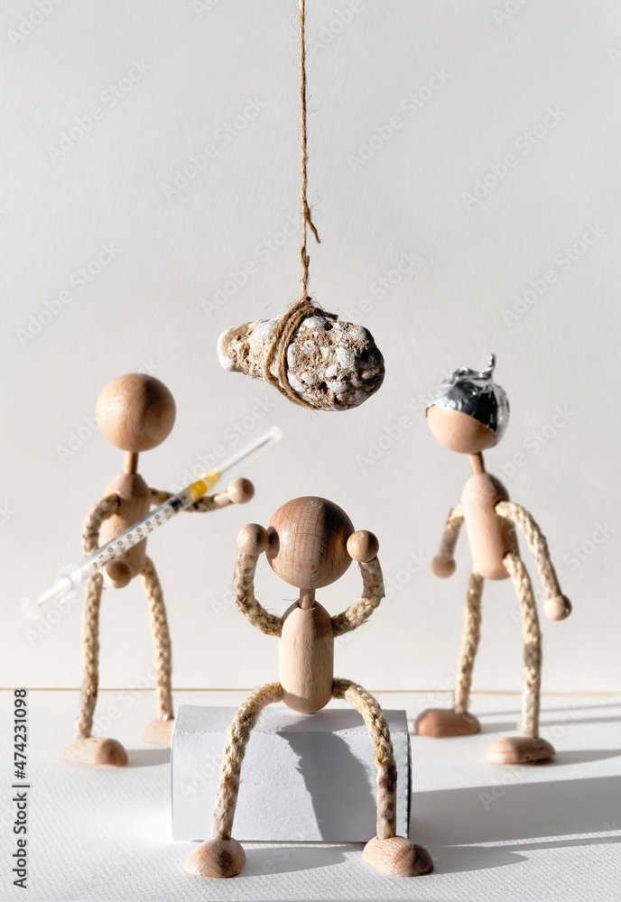 Dilemma of mandatory vaccination. Confused wooden toy man in fear of ...