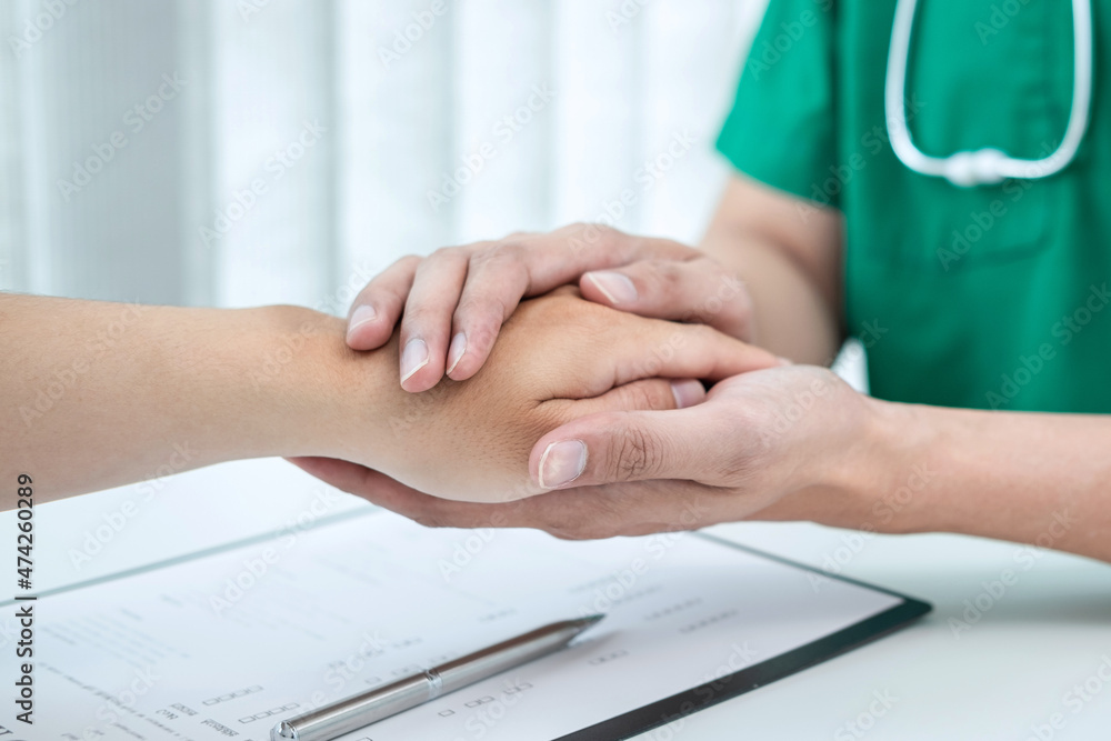 Hand of doctor touching patient reassuring for encouragement and ...