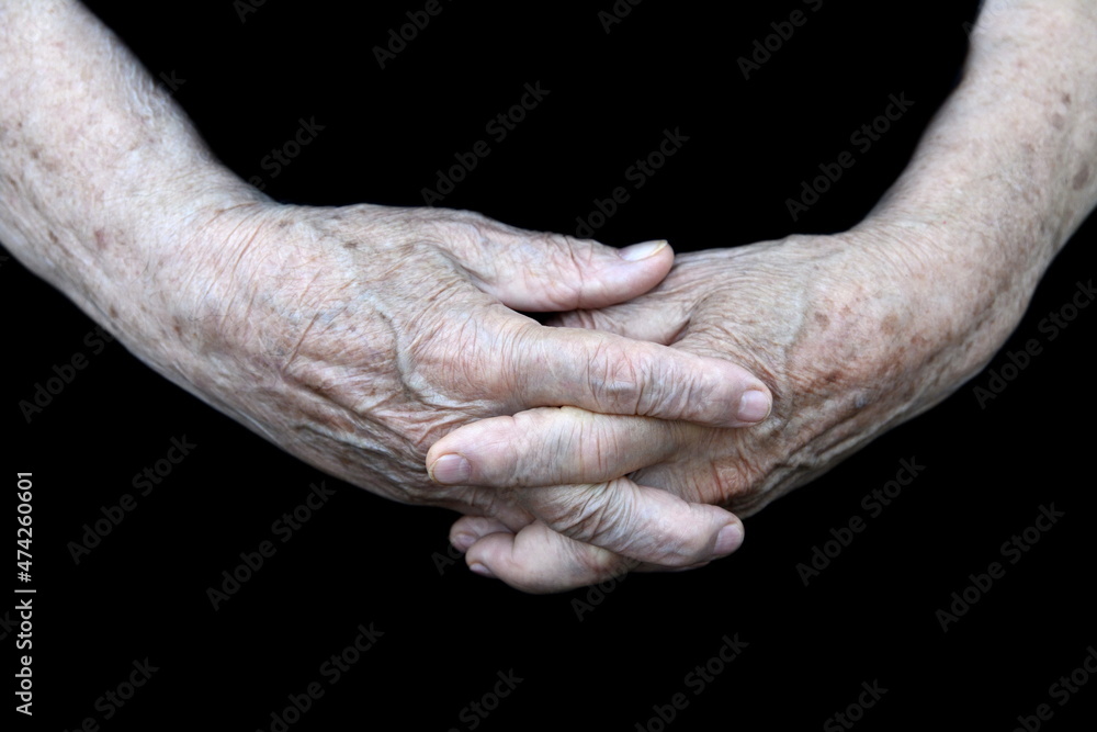 Aging process - very old senior woman hands isolated on black ...