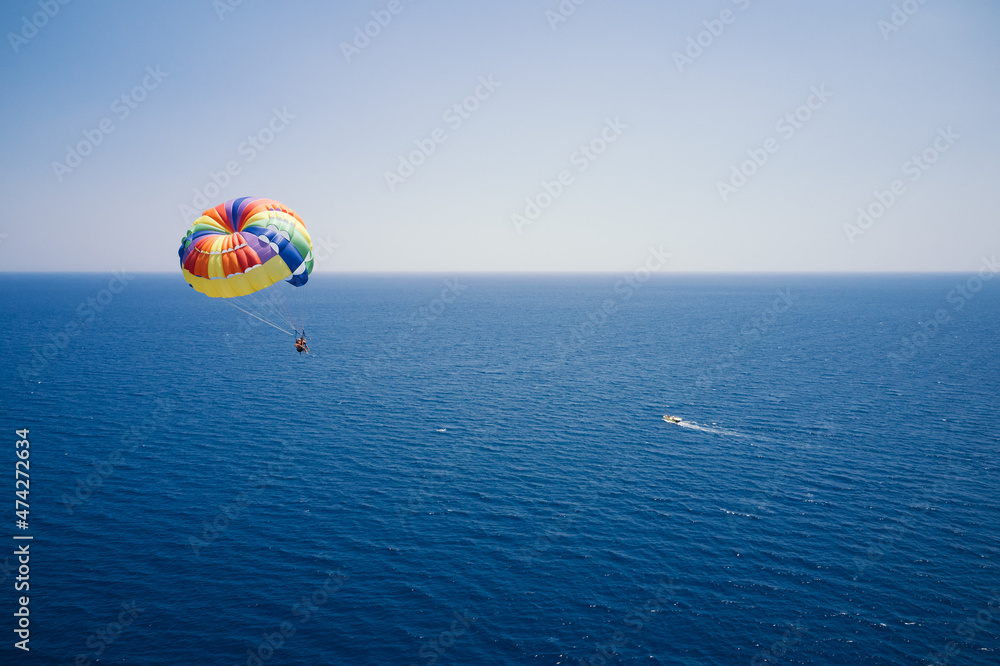Parasailing. Aerial view of flying family with a parachute behind a ...