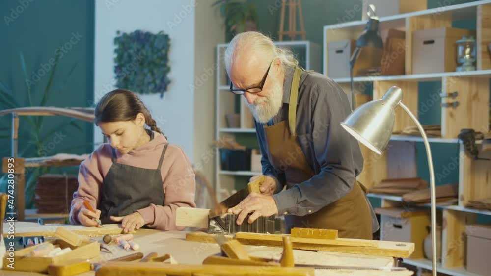 Grandfather Carpenter with his Teenage Granddaughter Work on Wood With ...