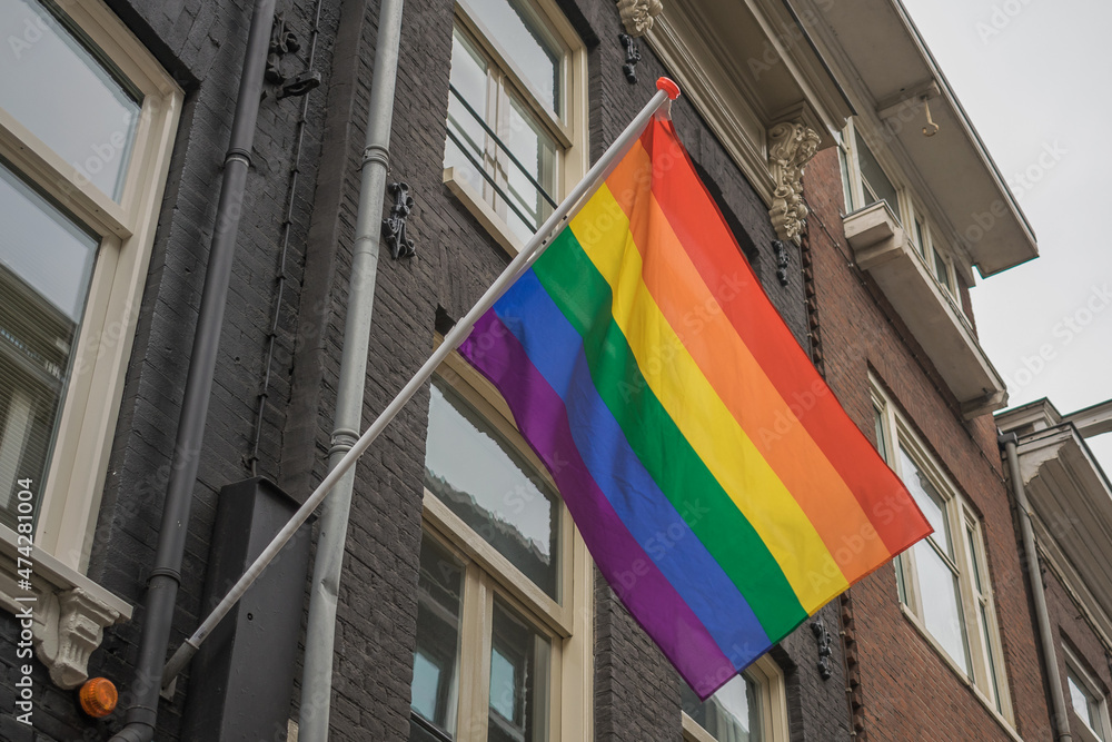 Gay flag in Amsterdam. Gay rainbow flag on a building. Rainbow flag of ...