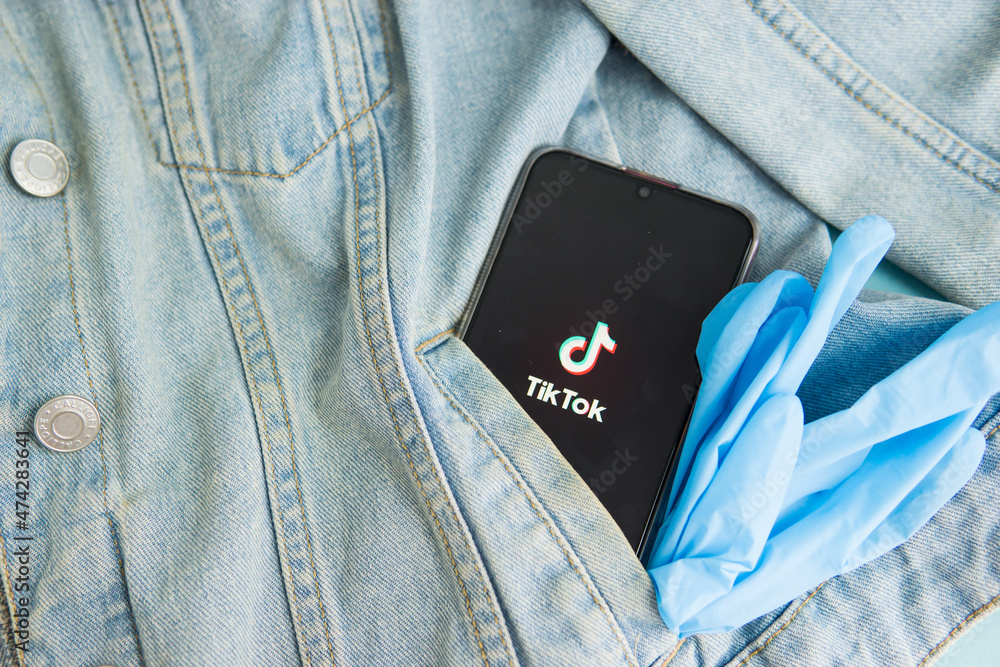 Tver, Russia-may 7, 2020, the tik tok logo on a smartphone screen sticks out of the pocket of a ...