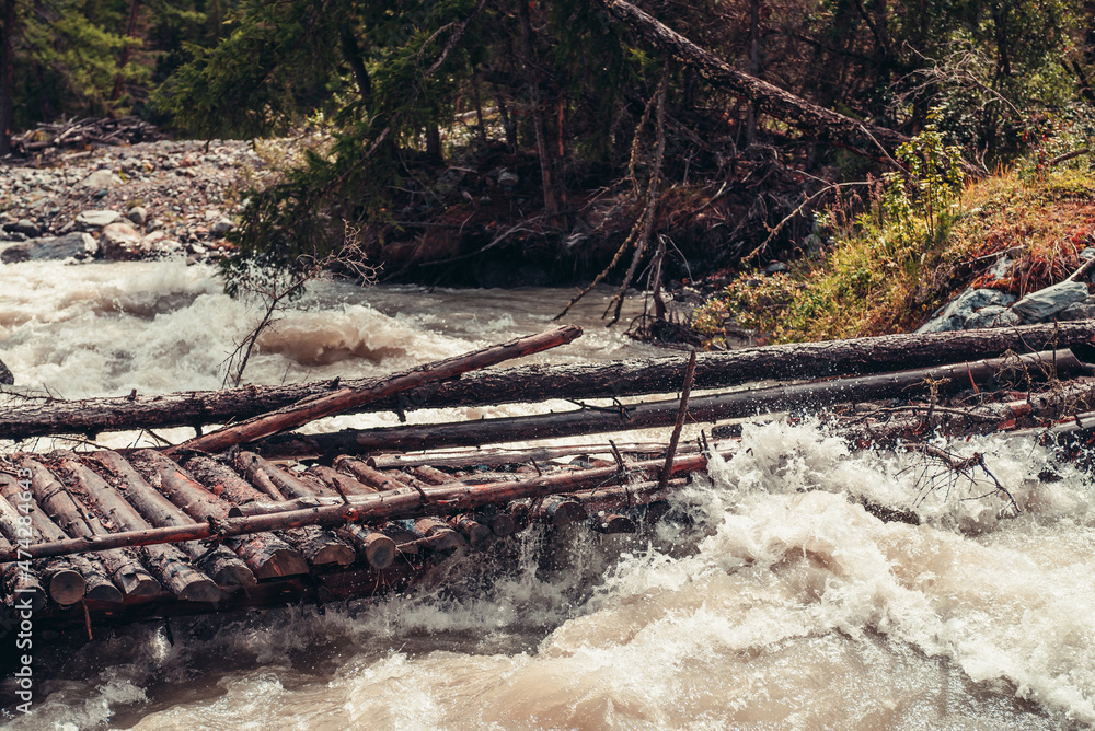 Fast turbulent river with broken bridge in water. Scenic mountain ...