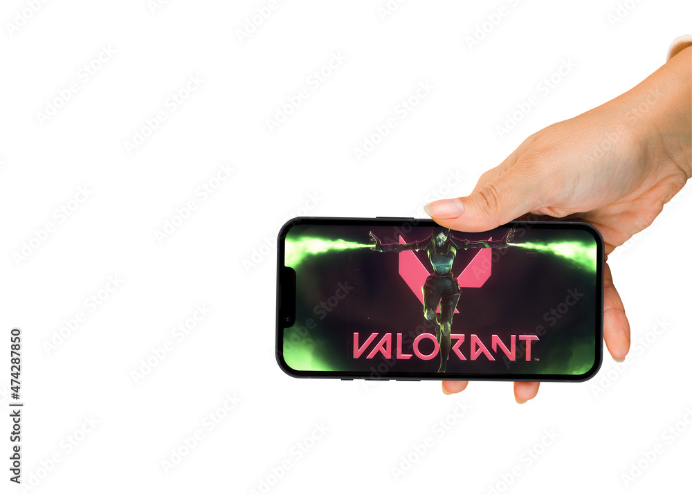 Female hand holding a smartphone with Valorant mobile game app on the ...