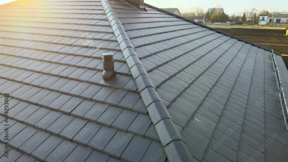 Closeup of ventilation pipe on house roof top covered with ceramic ...