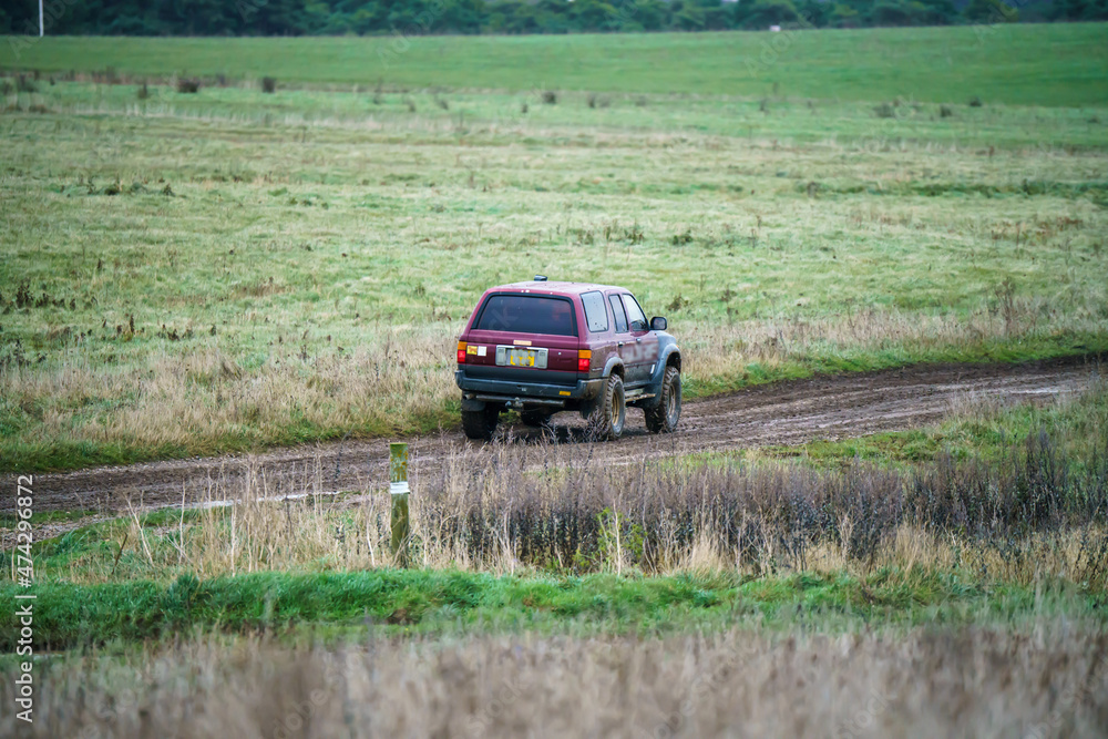 Toyota Hilux Surf 4Runner 4x4 off-road vehicle driving across mud ...
