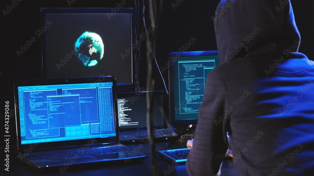 Back hooded hacker using malicious software hack corporate data center ...