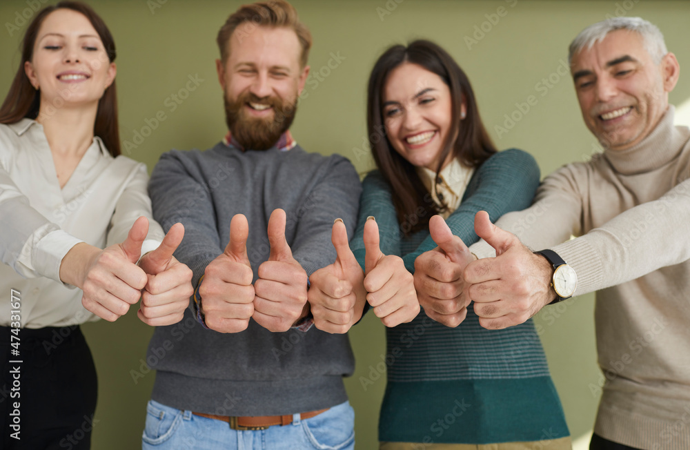 Happy people showing like gesture. Team of smiling excited senior and ...