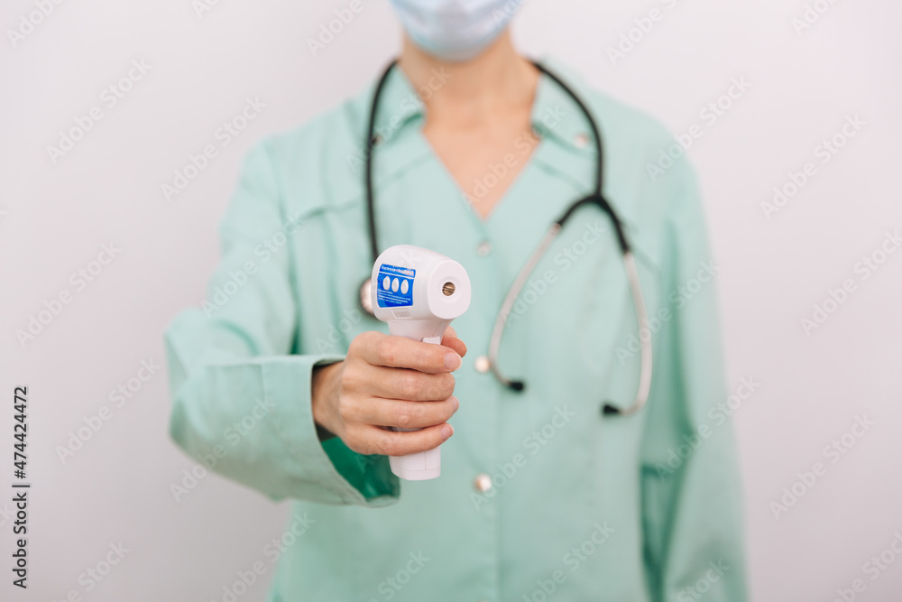 Temperature measurement gun in doctor hands. Close-up shot of doctor ...