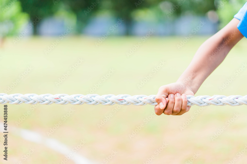 kid children hands holding rope playing tug of war during joint ...