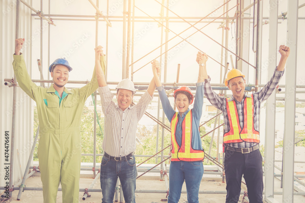 Engineer and worker team shake hand and arm up for congratulation to ...