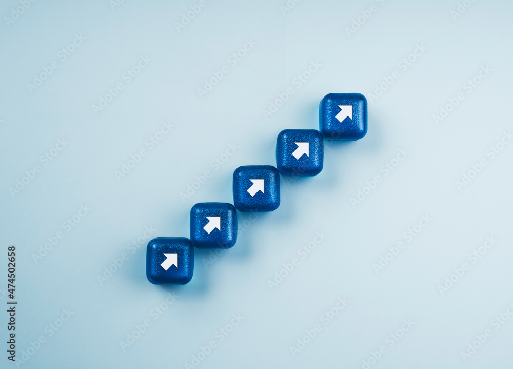 White rising arrows, increase symbol on blue cube blocks stacking as a ...