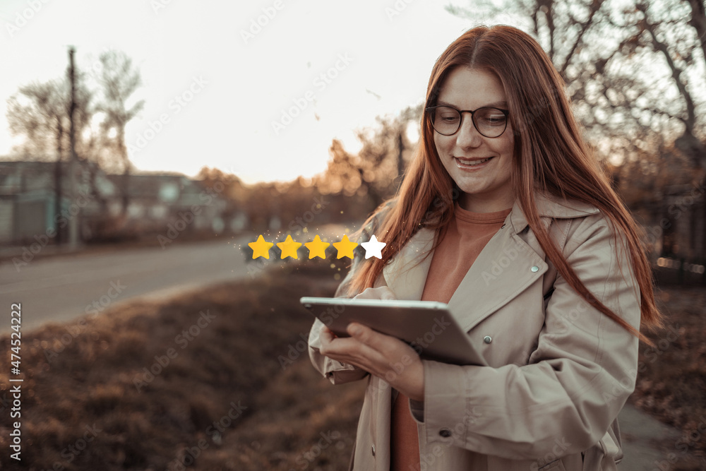 Excellent. Person using tablet notepad with icon 4 star symbol to ...