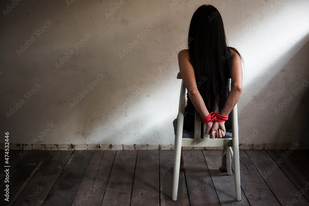 Hostage woman tied on chair in abandon house Stock Photo | Adobe Stock