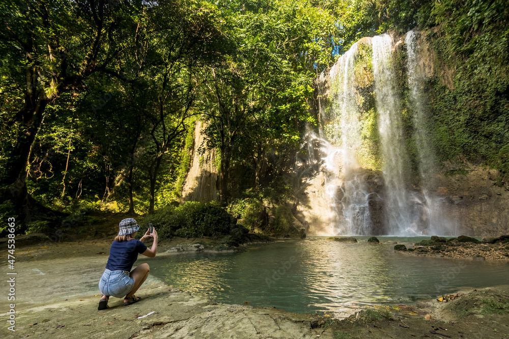 A tourist takes a picture of Kawasan Falls in Balilihan, Bohol ...