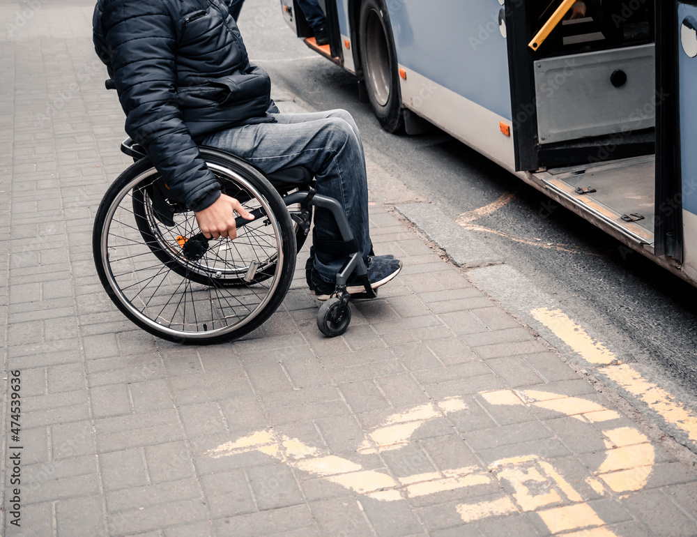 Person with a physical disability enters public transport with an ...