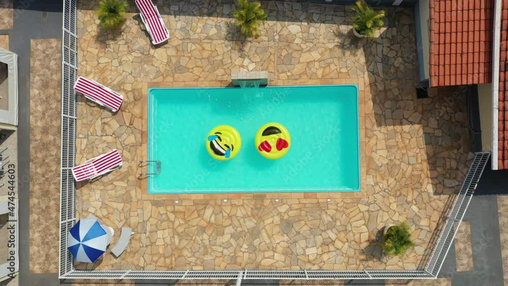 Aerial view of smile emoji float at swimming pool. Float smile emoji ...