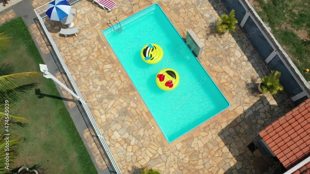 Aerial view of smile emoji float at swimming pool. Float smile emoji ...