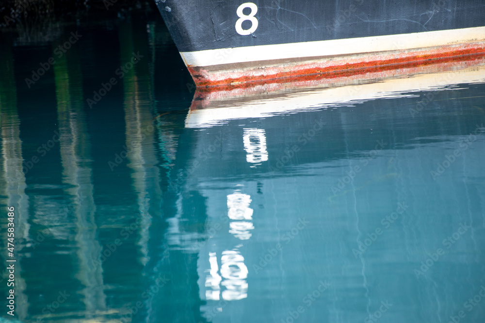 The bow of a large blue ship with the number eight waterline marker in ...