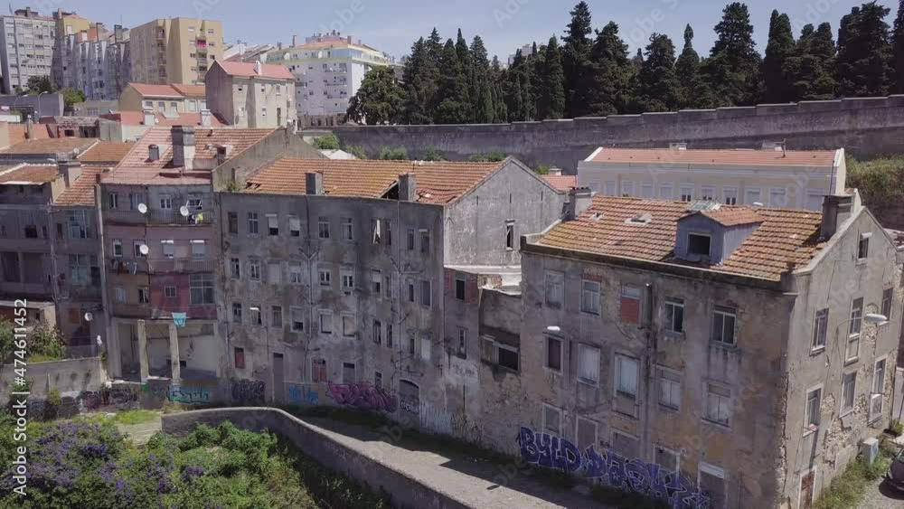 Drone aerial tracking shot of run-down buildings in Casal Ventoso, a ...