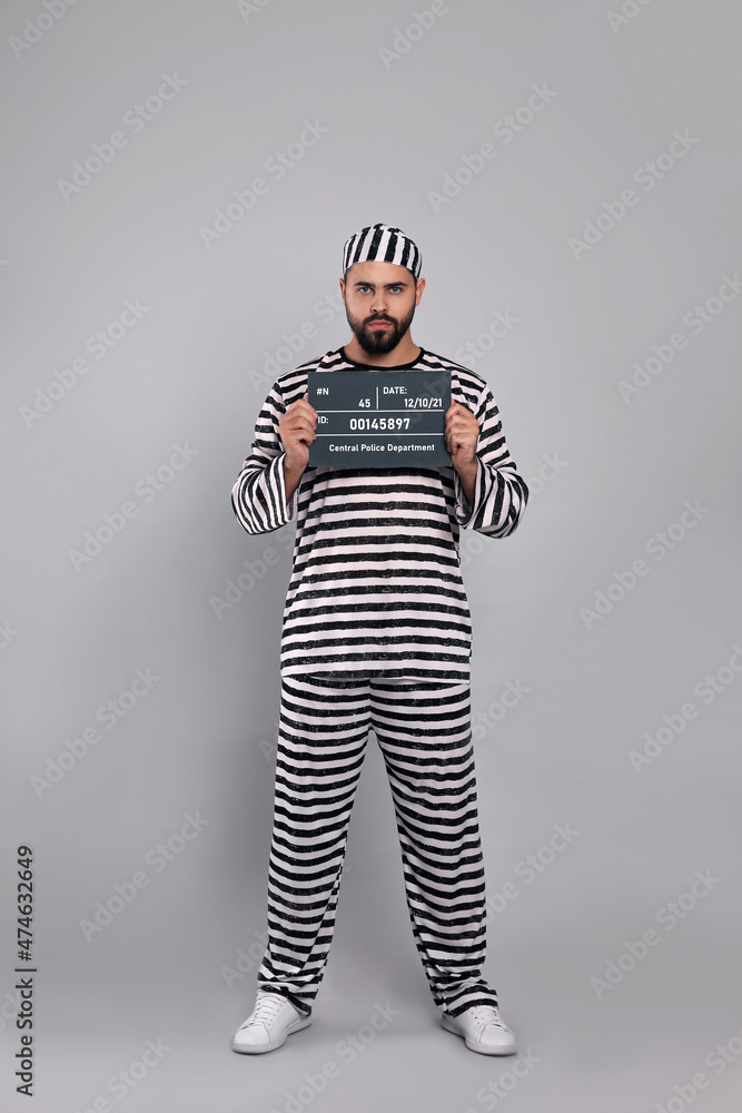 Prisoner in special uniform with mugshot letter board Stock Photo ...