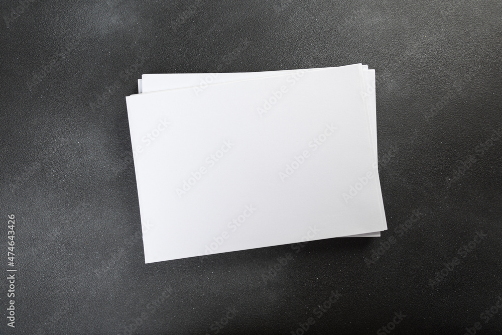 White business card sheet of paper a4 stack on a dark table. Clean ...