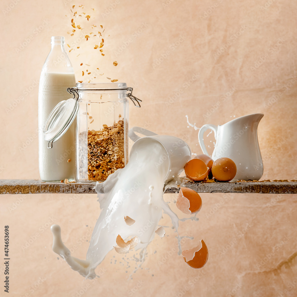 milk, cereals and eggs standing on wooden shelf,milk is falling out ...