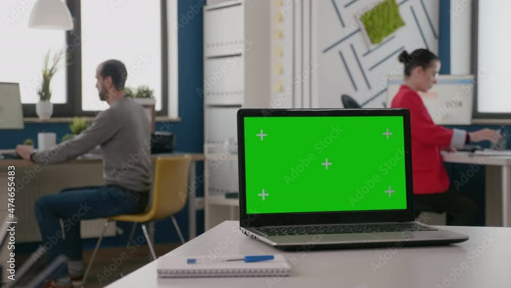 Close up of isolated green screen on laptop at empty desk. Device with ...