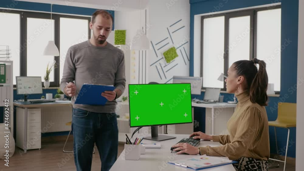 Team of coworkers using computer with green screen in startup office ...
