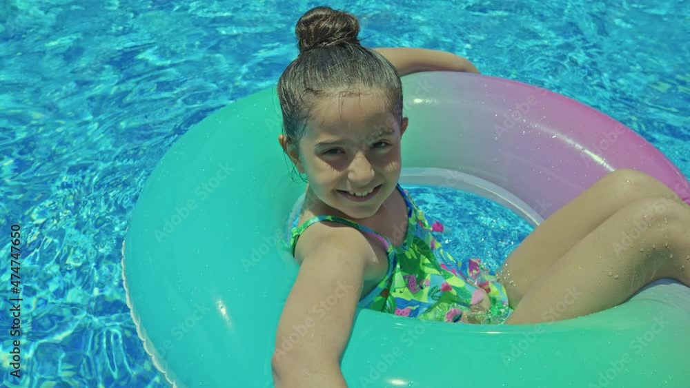 Little girl swimming in the pool, having fun.Little girl partying ...