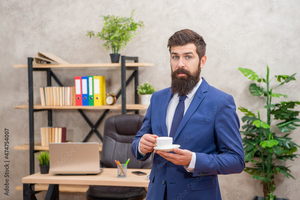 amazed brutal ceo in businesslike suit hold morning coffee cup at the ...