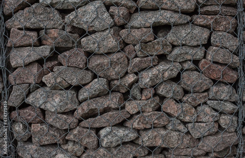 Rocks in cage background texture. Gabions by the river. Rock wall ...