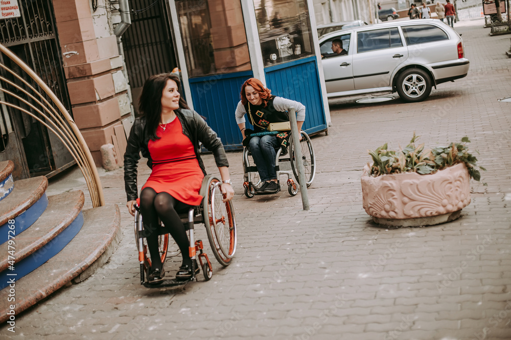 Girls in wheelchairs drive around obstacles in a city inaccessible to ...