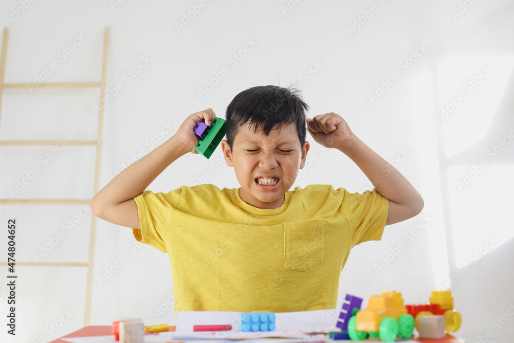 Emotional Tantrum and Angry boy while playing colorful bricks at home ...