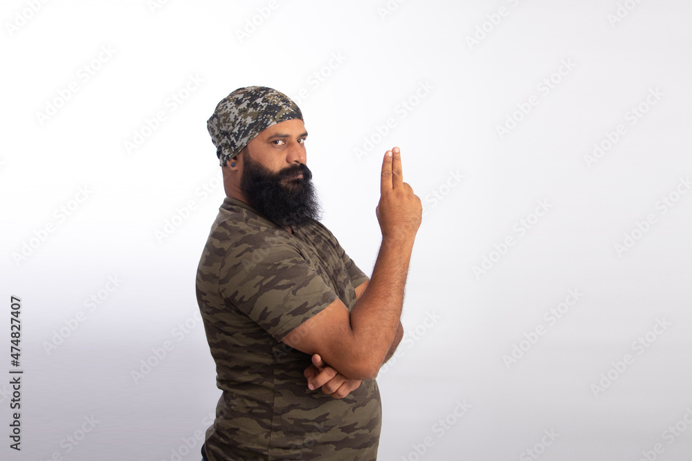 Unhappy angry Indian bald man, Fold arms imitates gun shoot gesture ...