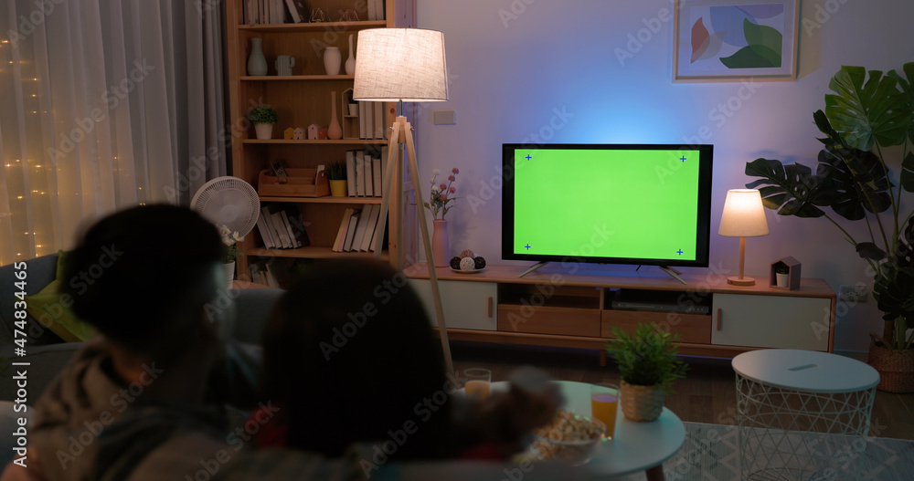 couple watch green screen TV Stock Photo | Adobe Stock