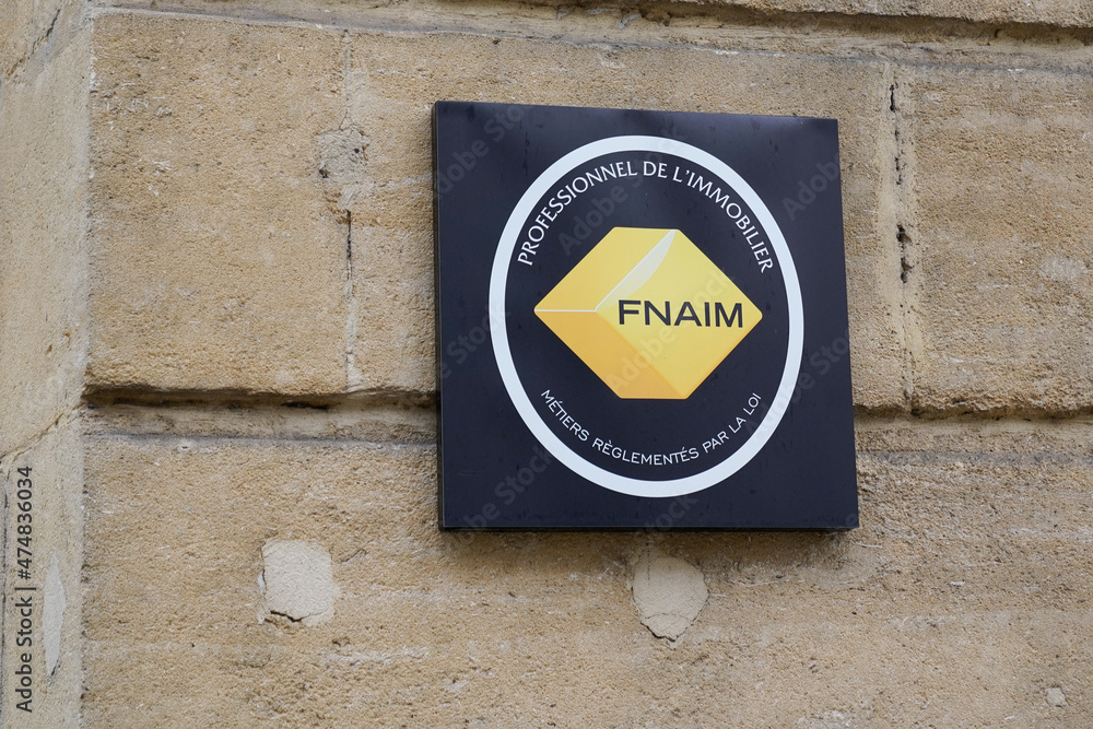fnaim logo yellow brand facade and text sign front of entrance wall ...