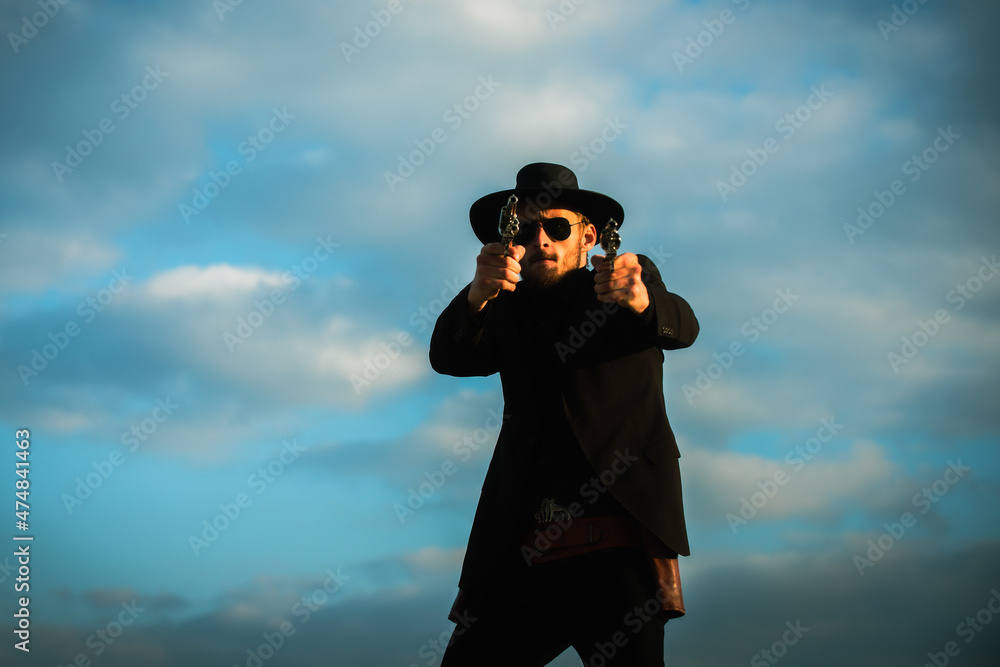 Sheriff or cowboy in black suit with vintage pistol revolver and ...