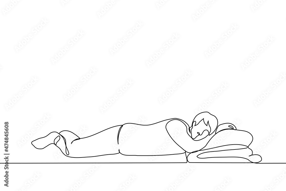 man is lying on bed with stomach down, he is sleeping on own hand - one ...