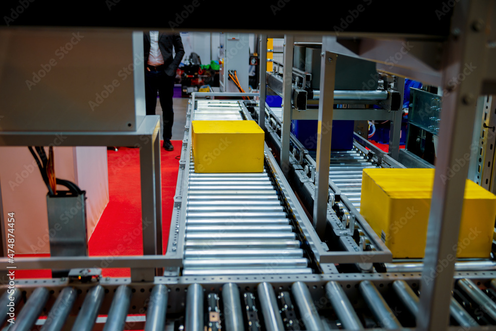 Warehouse automation. Automated conveyor lines with robotic manipulator ...