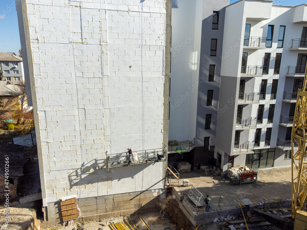 Construction worker insulating house wall with styrofoam insulatuion ...