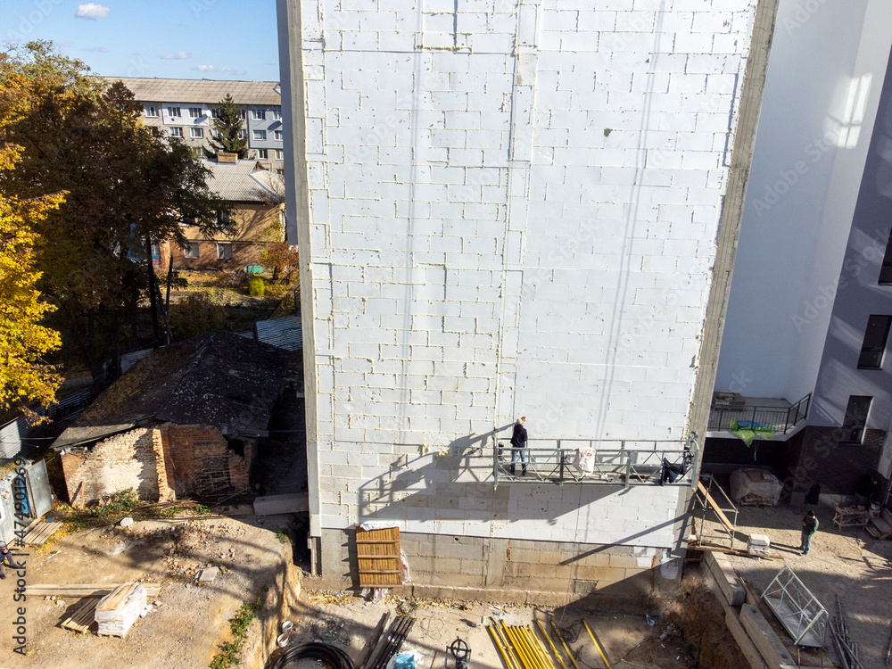 Construction worker insulating house wall with styrofoam insulatuion ...