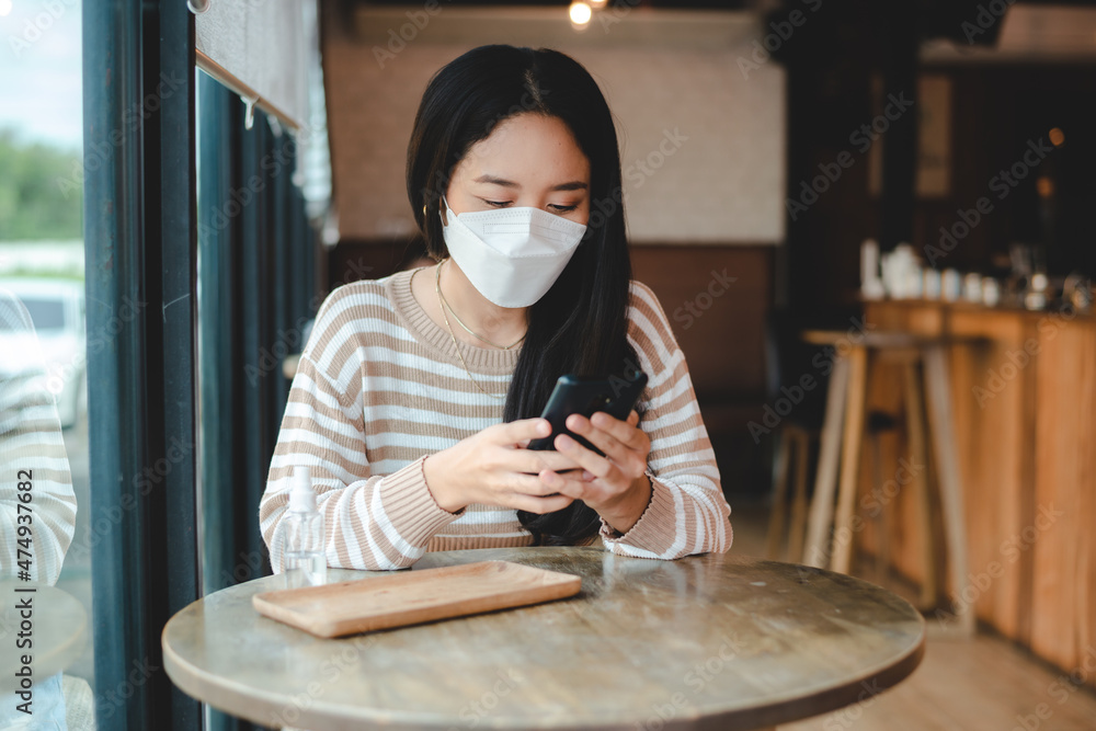 young Asian woman wearing surgical face mask for a new normal lifestyle ...