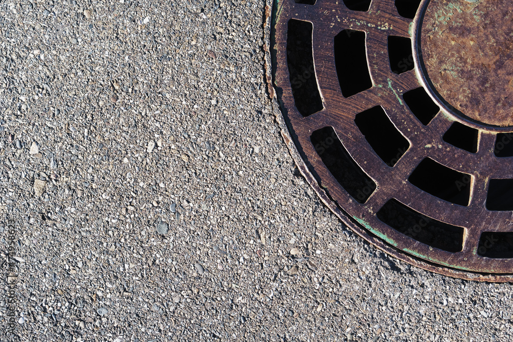 Sewer round hatch with a grate on an asphalt road. Stock Photo | Adobe ...