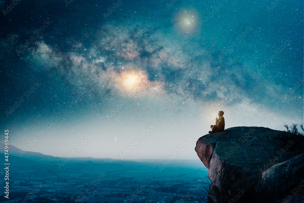 person sitting on the top of the mountain meditating or contemplating ...