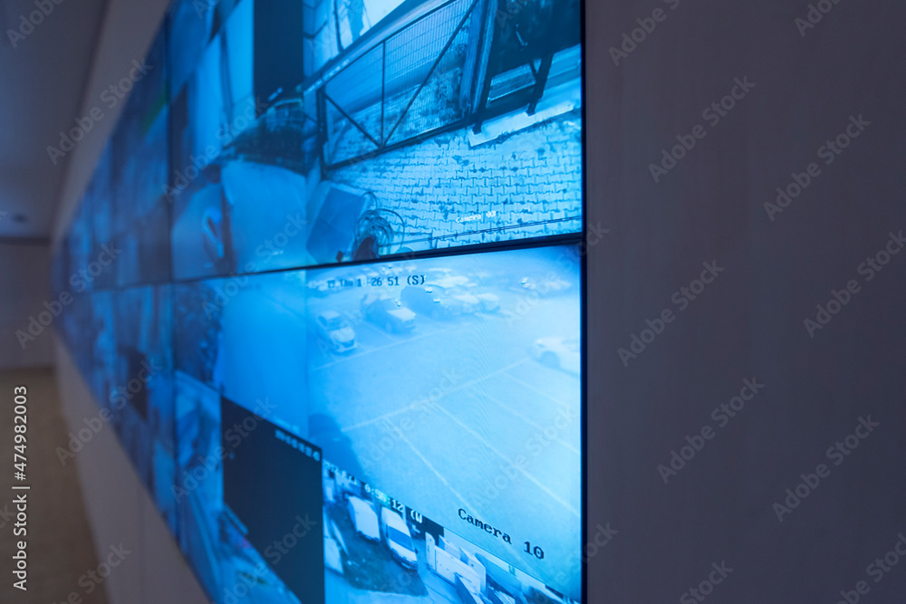 Security guard monitoring modern CCTV cameras in surveillance room ...